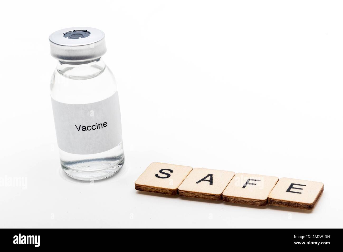 Vaccine concept showing a medical vial with a Vaccine label on a white ...