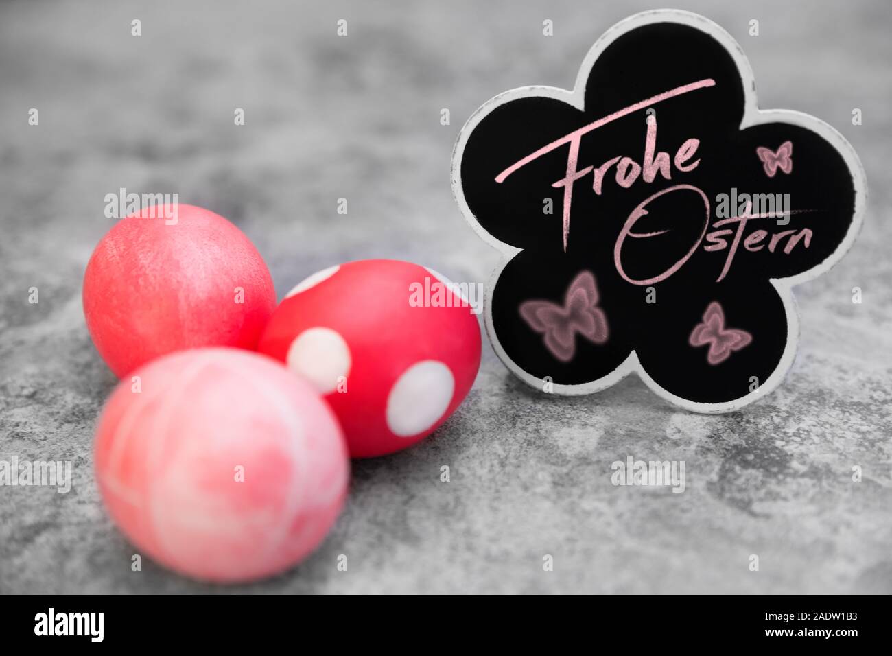 Easter greeting card with red colored eggs and slat with german text ...