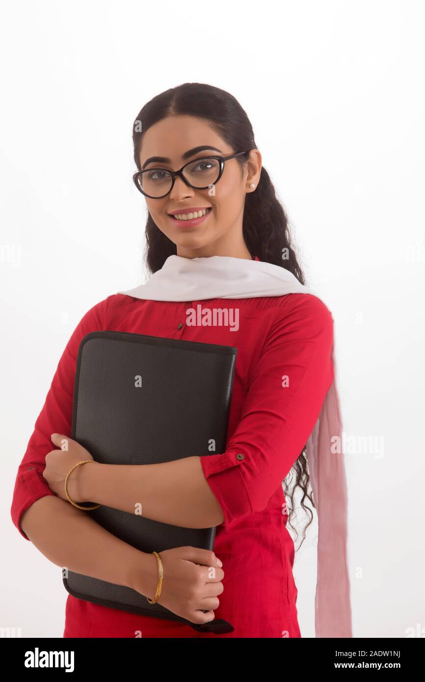 Portrait of a happy single woman standing with a folder in hand Stock ...