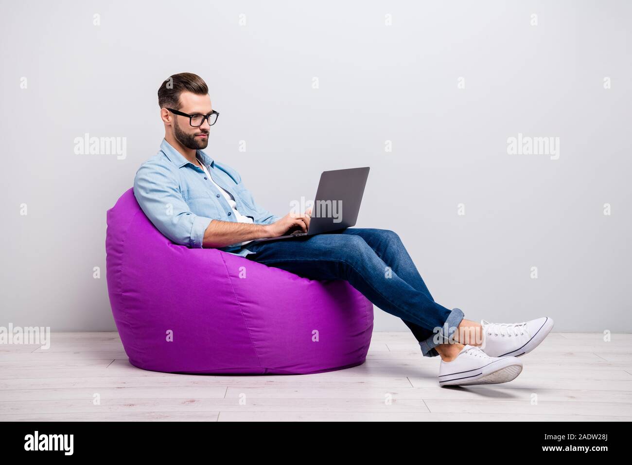Full length profile photo of attractive guy holding notebook browsing ...