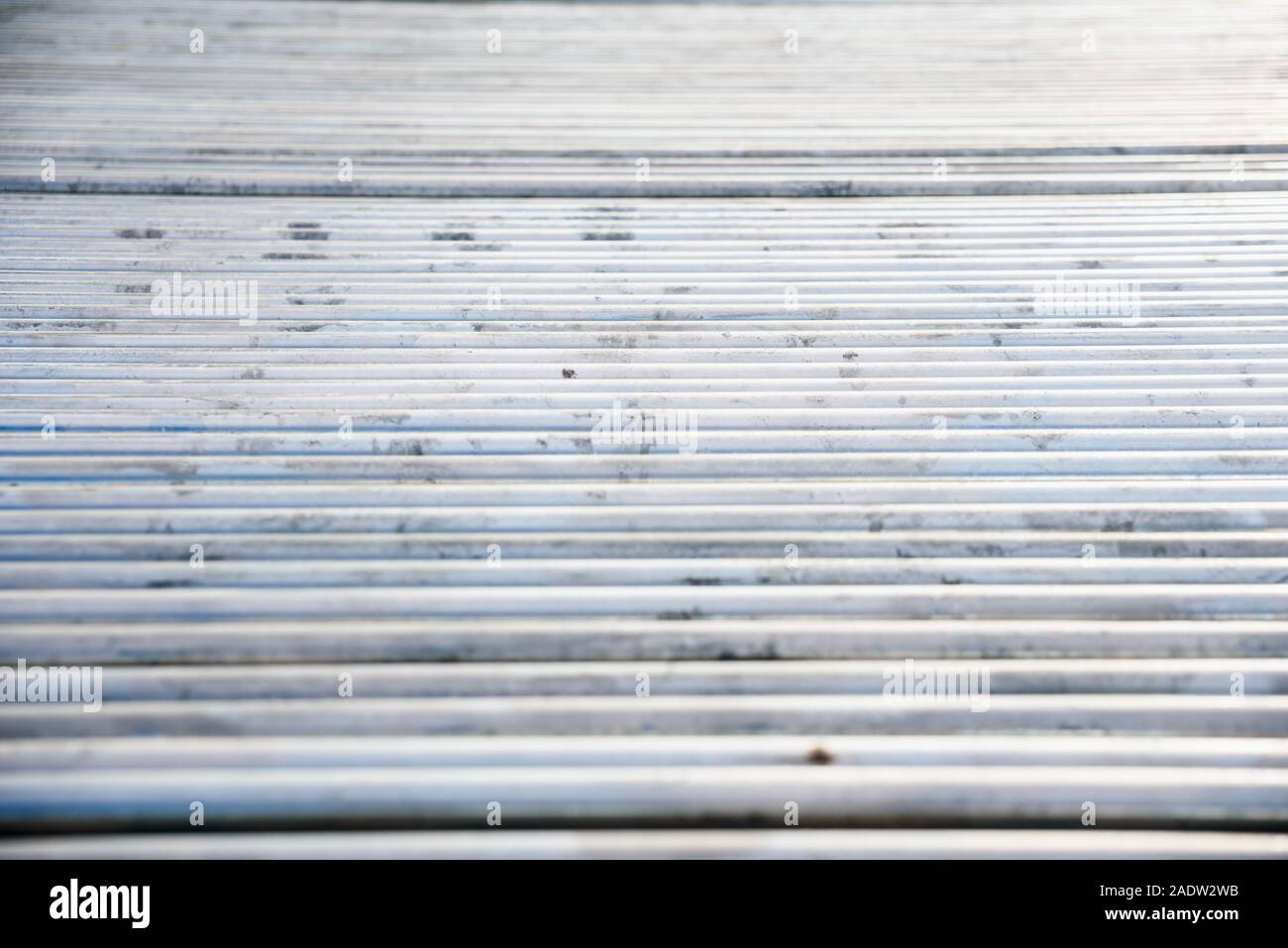 Silver steel metal bar close-up, with unfocused background, industrial ...
