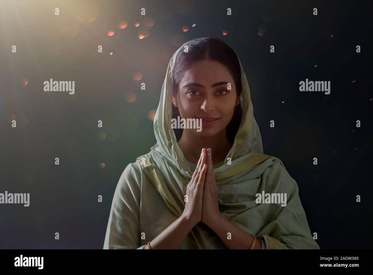 Portrait of a single woman praying with her hands folded Stock Photo ...