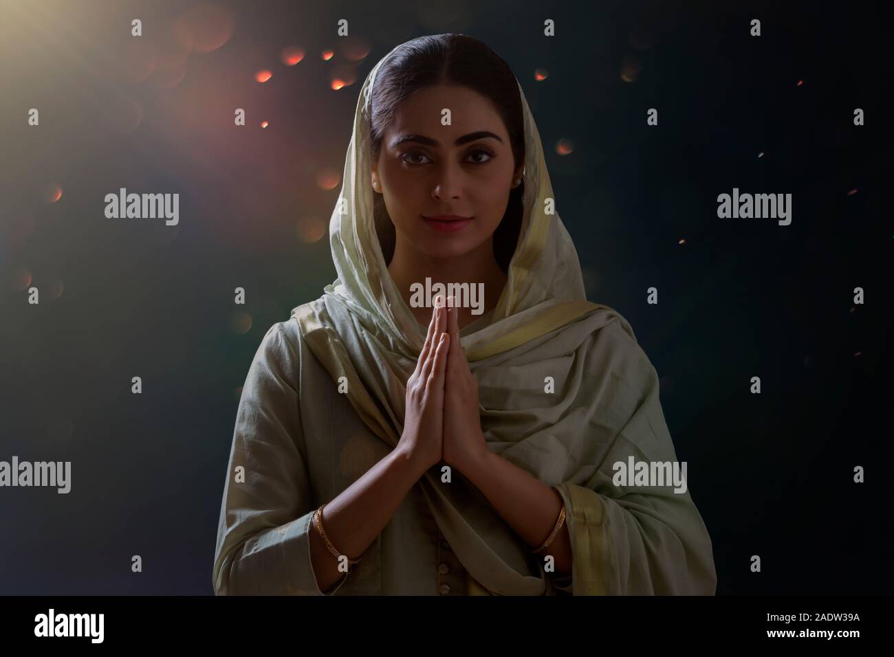 Portrait of a single woman praying with her hands folded Stock Photo ...