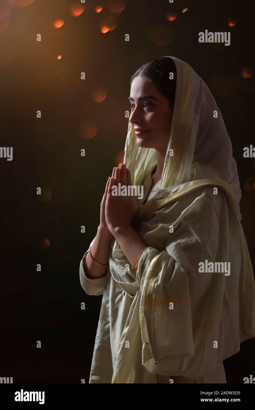 Portrait of a single woman praying with her hands folded Stock Photo ...