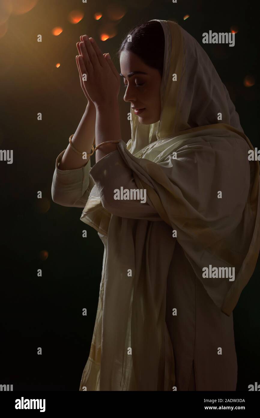 Portrait of a single woman praying with her hands folded Stock Photo ...