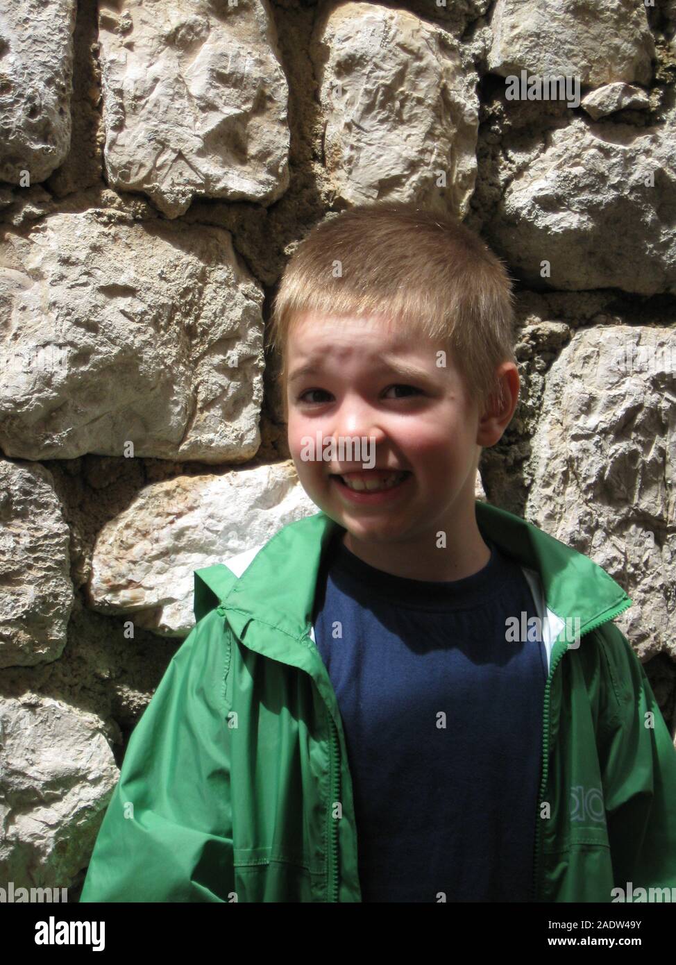 Boy portrait, stony background, funny face expression Stock Photo - Alamy