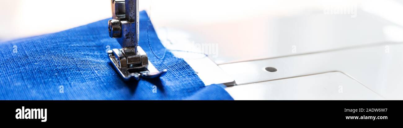 panorama with a closeup of a sewing machine and blue linen, header with ...