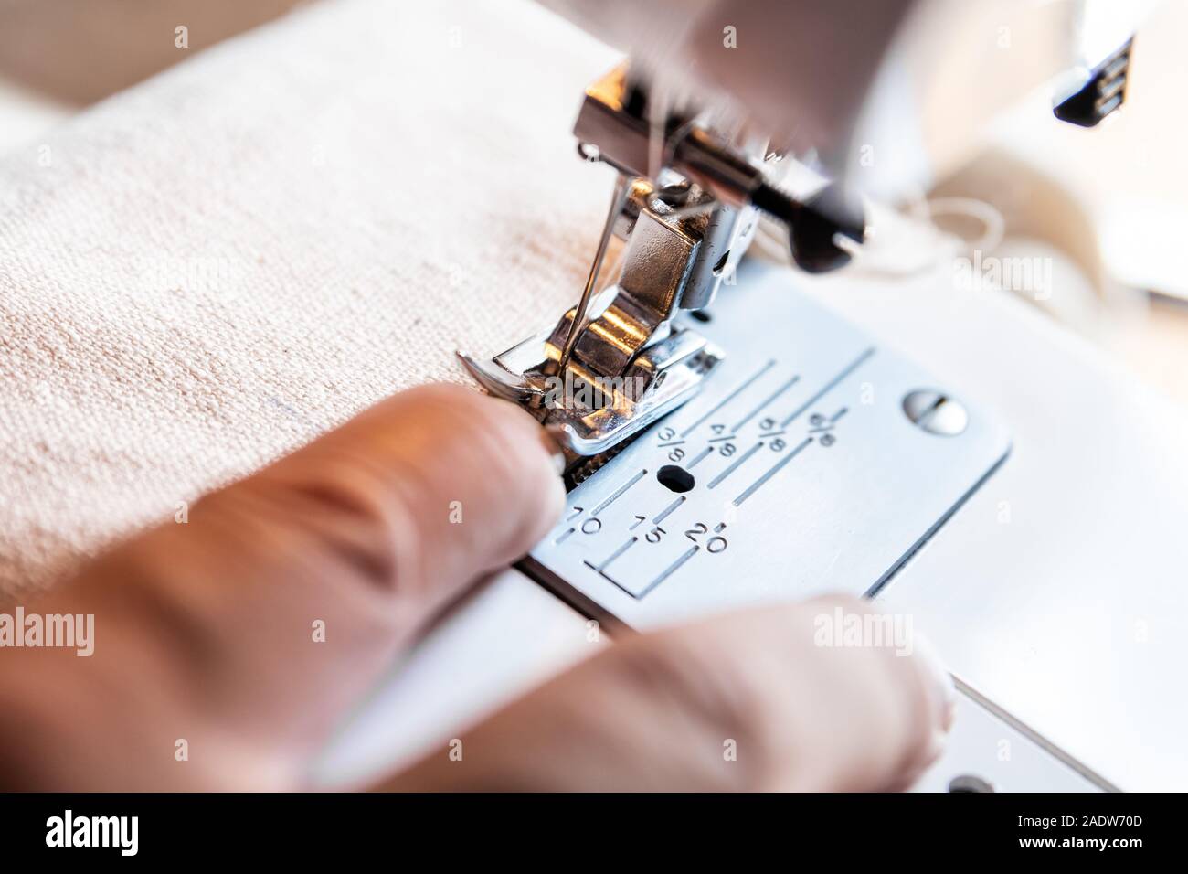 man is having a nasty accident with a sewing machine, sewing needle in ...