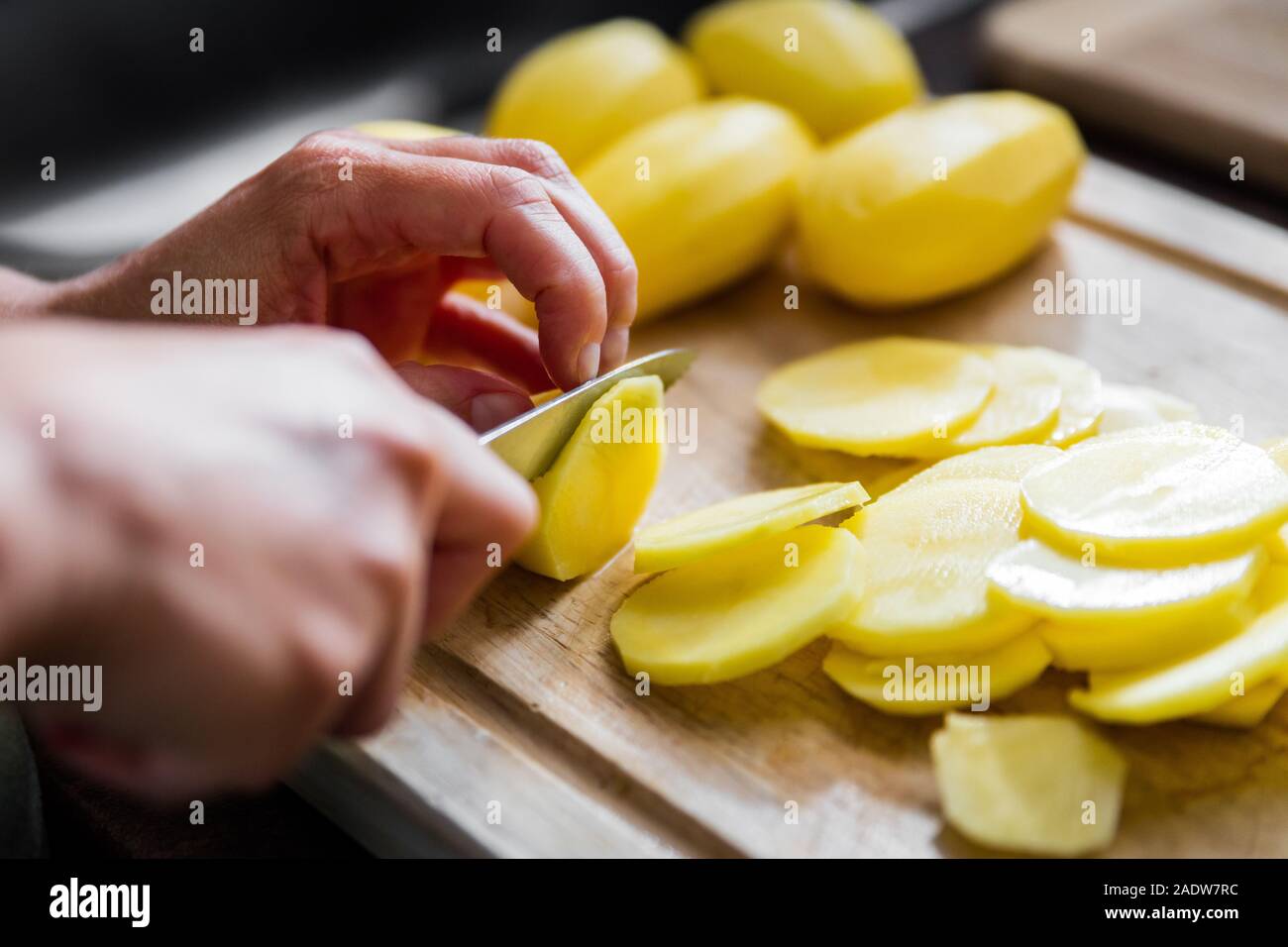 Woman slices potato knife hi-res stock photography and images - Alamy