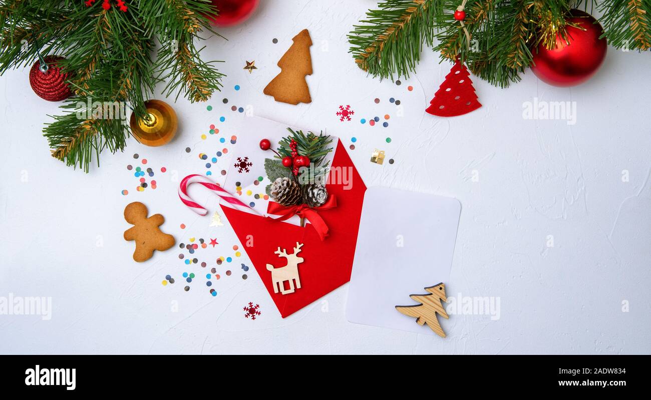 Photo of red envelope, cookies, branches of spruce Christmas ...