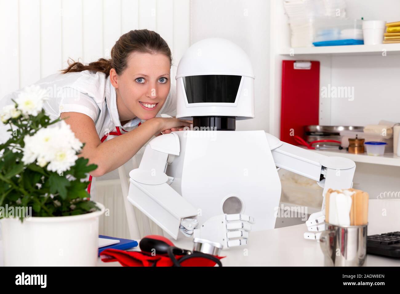 autonomous medical robot doctor is sitting behind the desktop in a ...