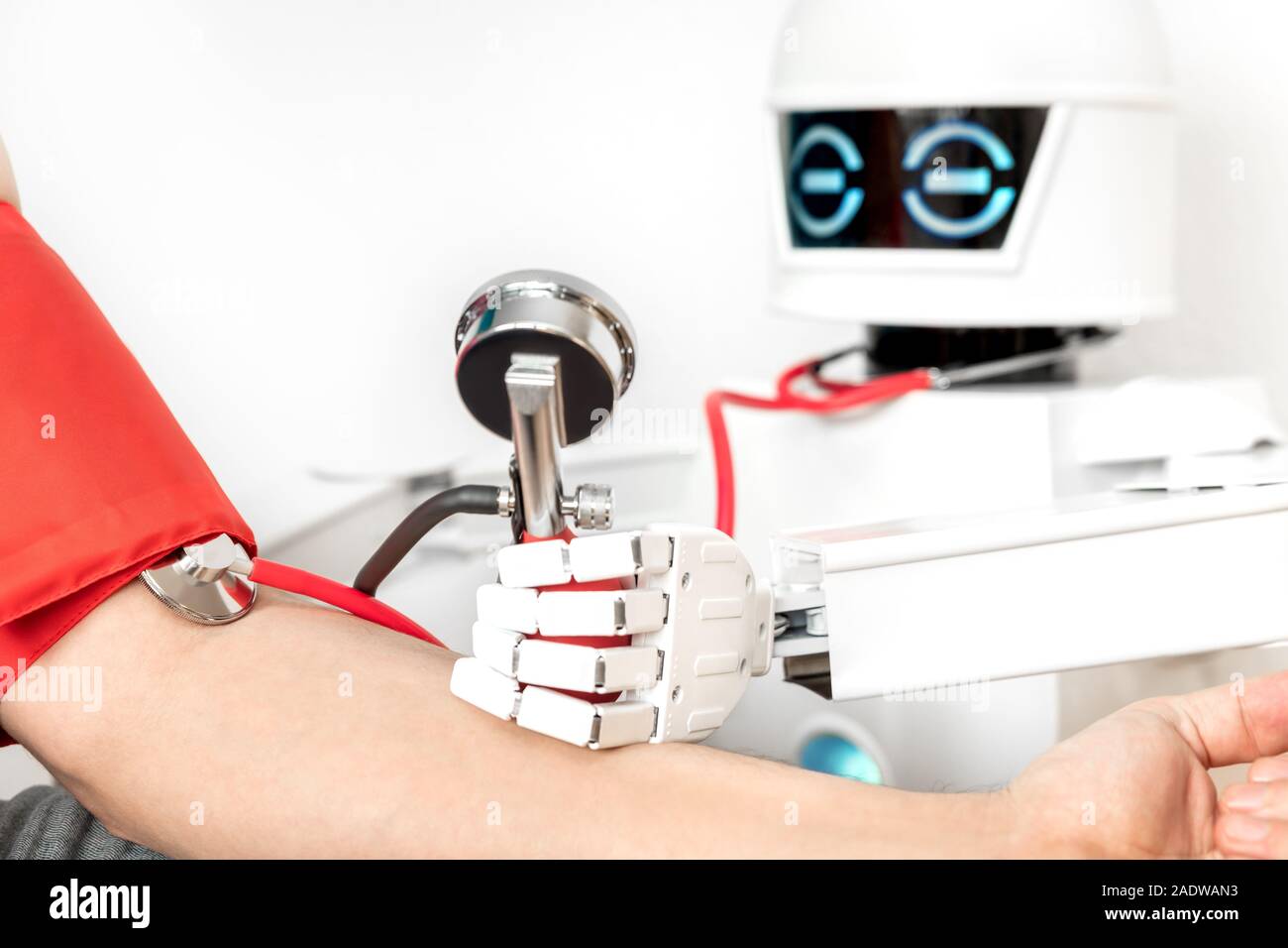 medical assistance robot is checking the blood pressure of a male ...