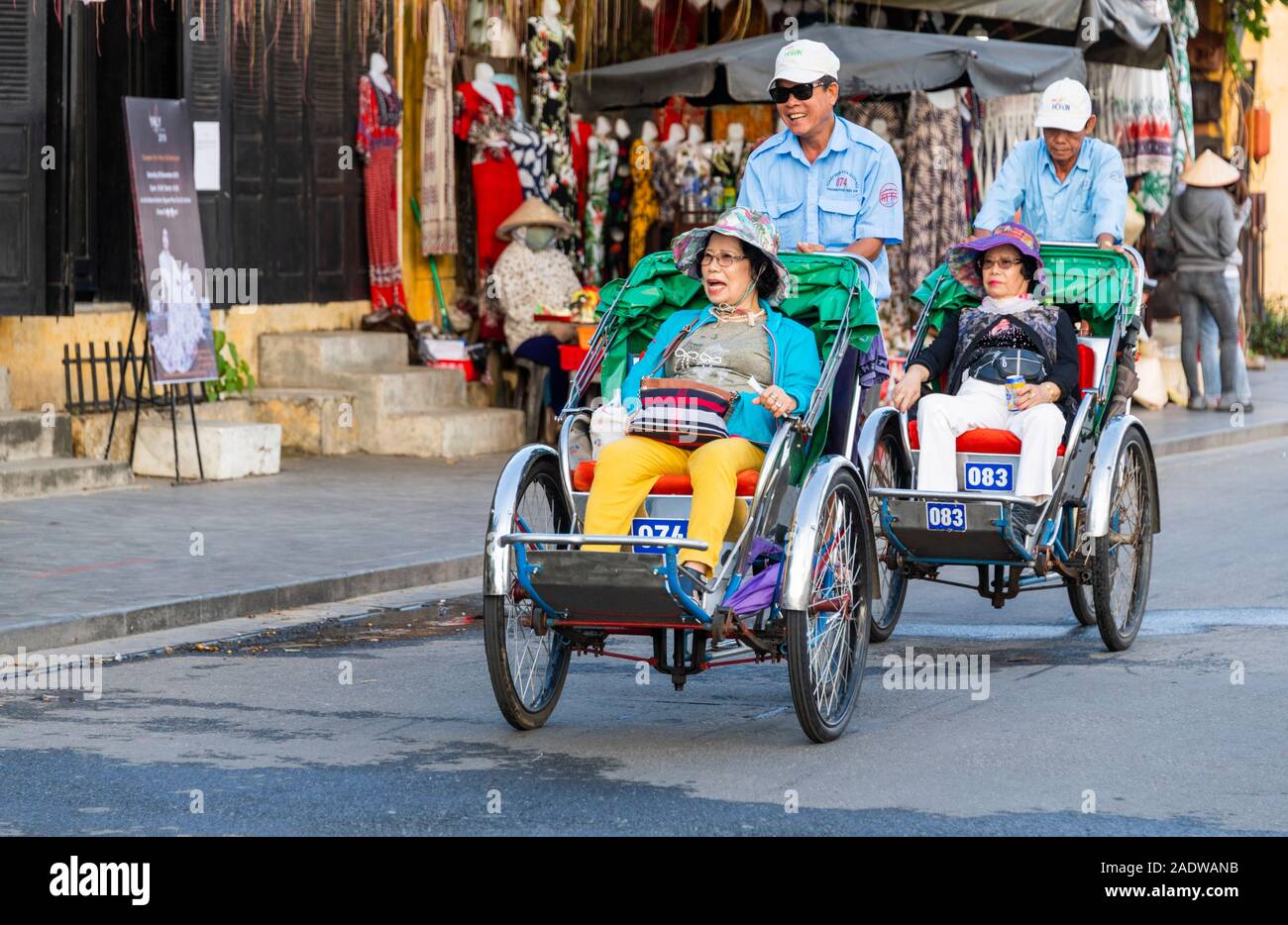 Asian tourists enjoying cyclo/rickshaw ride around Hoi An Vietnam Stock ...