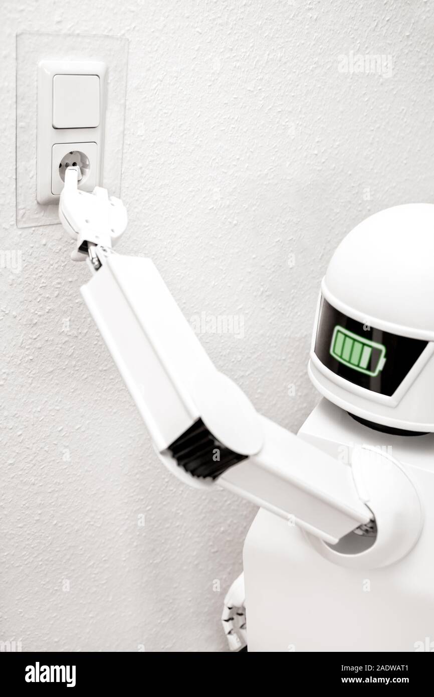 white robot is recharging himself on a german socket, holding his ...