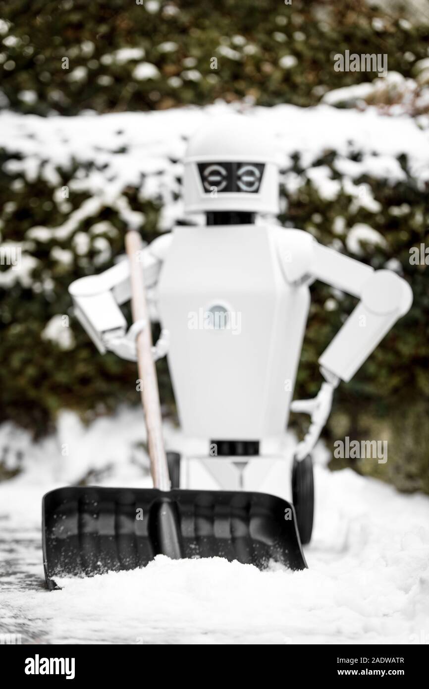 service robot is shovelling snow in the winter, portrait of the ...