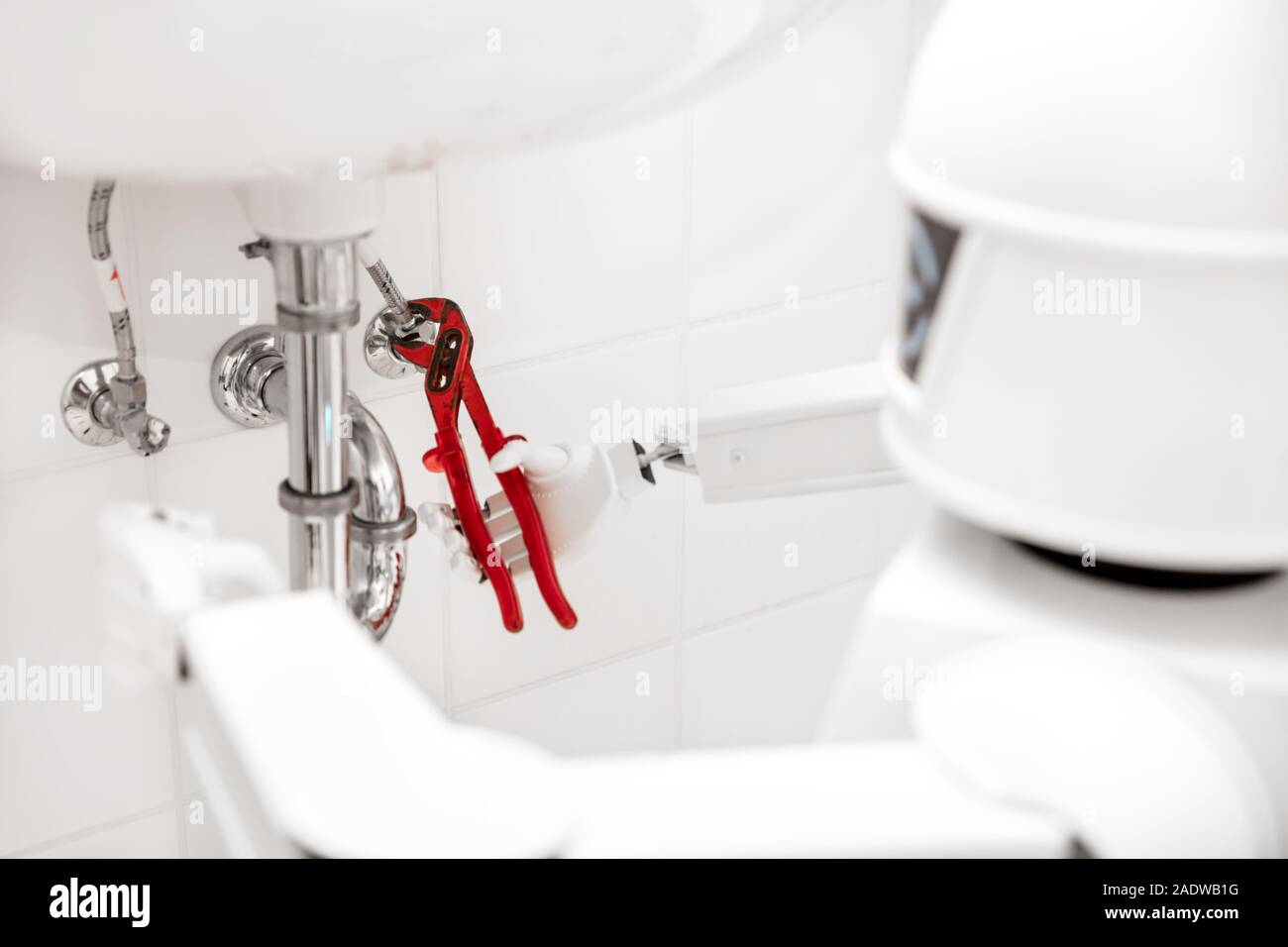 Autonomous service robot is fixing something in the bathroom, with an ...