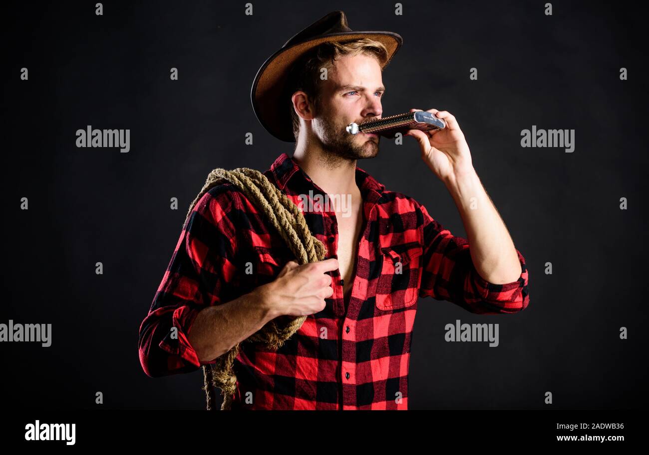 Sheriff concept. Brutal cowboy drinking alcohol. Western culture ...