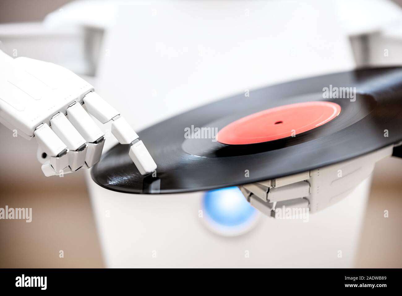 music robot is playing a record while touching with his finger the ...