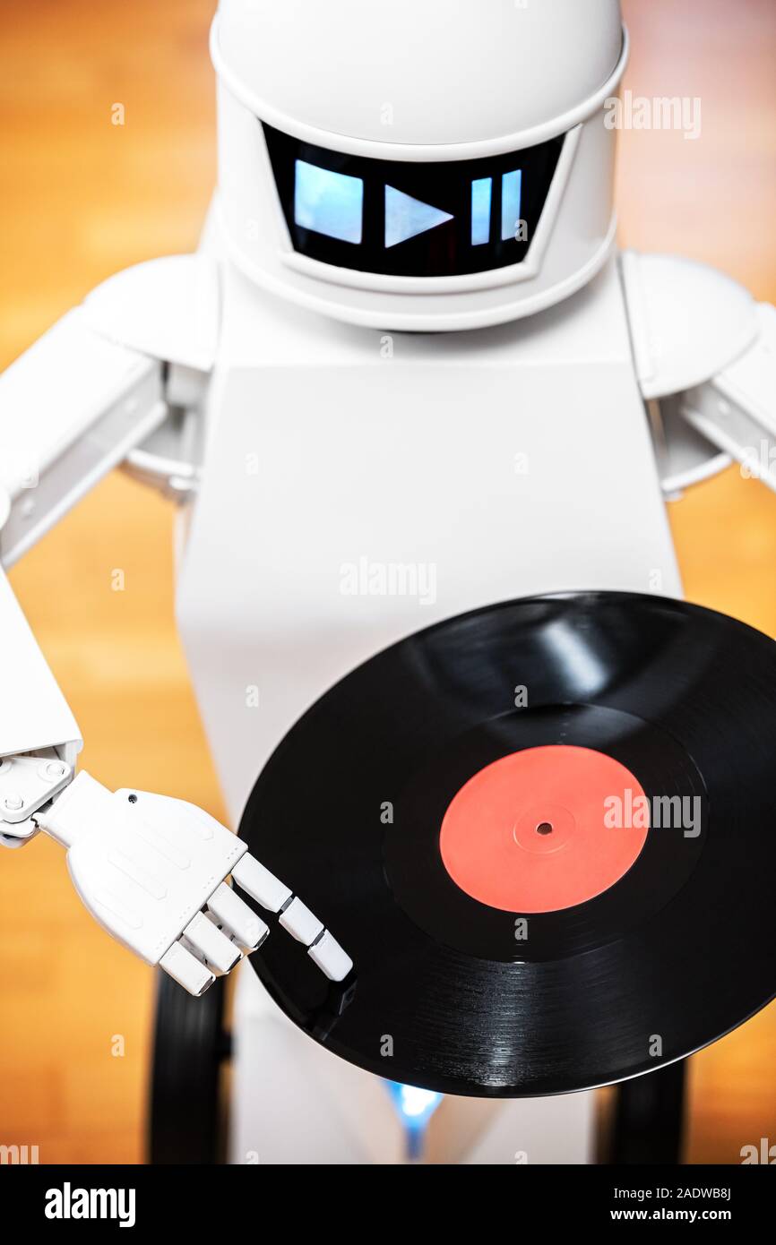 music robot is playing a record while touching with his finger the ...