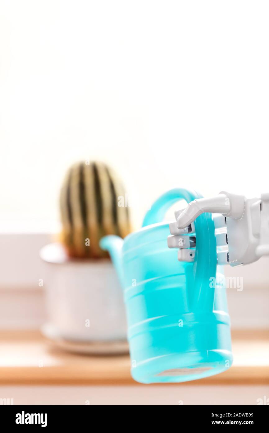 a robotic prosthesis arm with watering can is watering a cactus in ...
