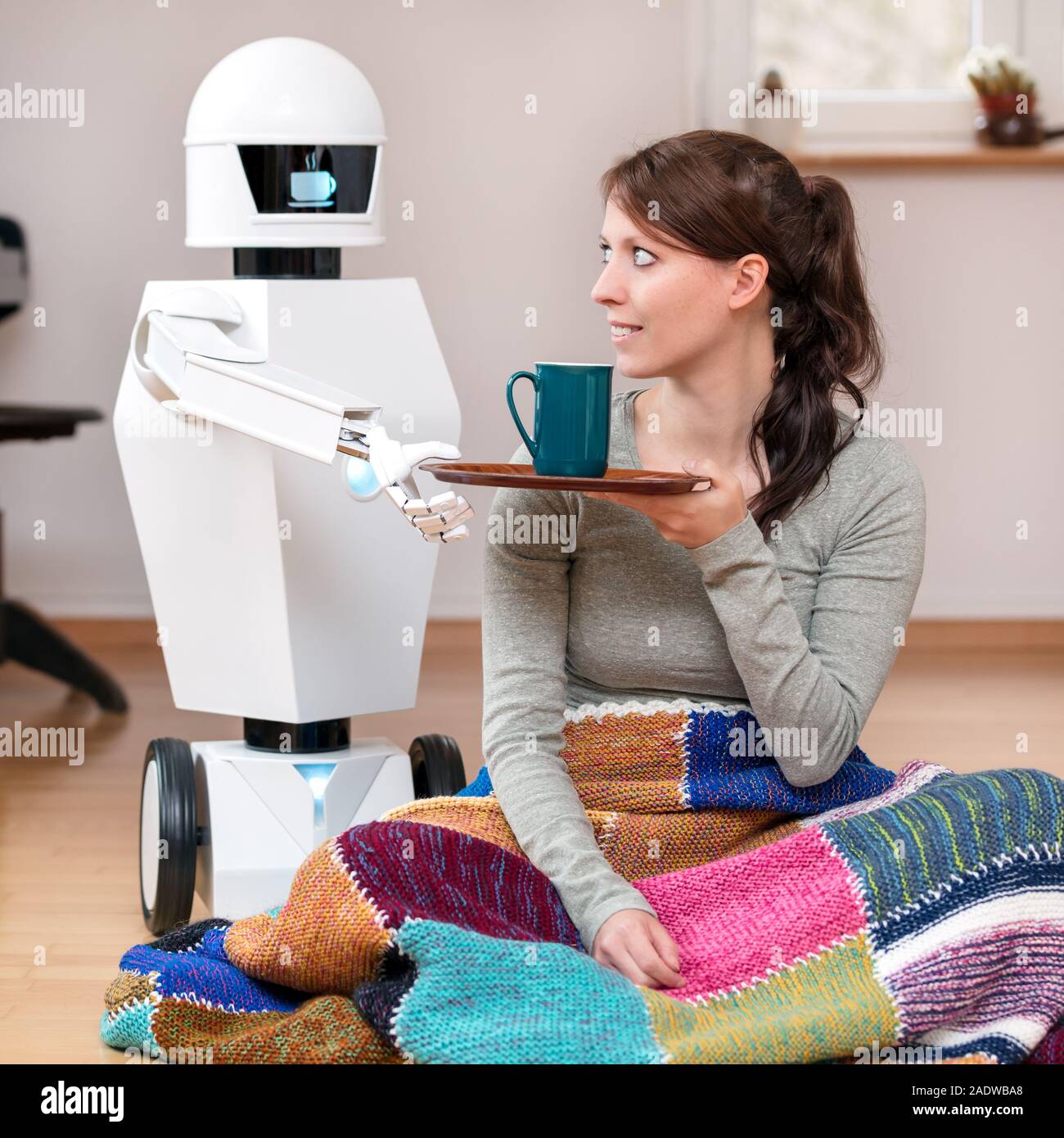 service robot is giving a brunette, pretty woman a coffee in the living ...