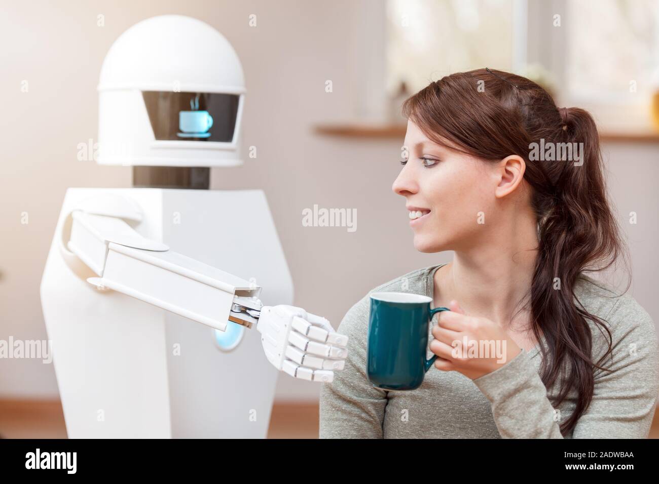 service robot is giving a brunette, pretty woman a coffee in the living ...