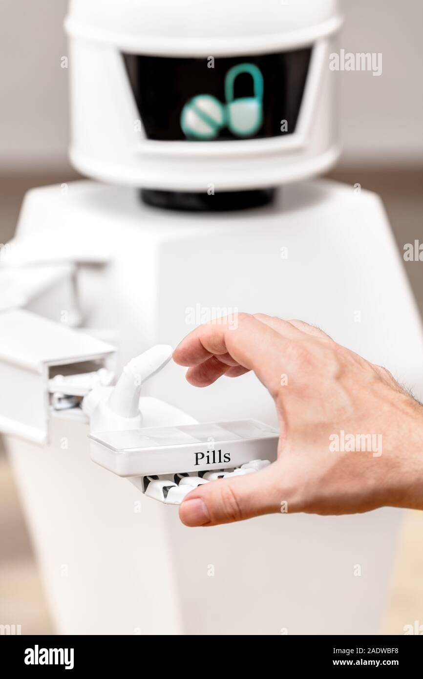 service medicine or care robot is giving some pills to a man. his ...