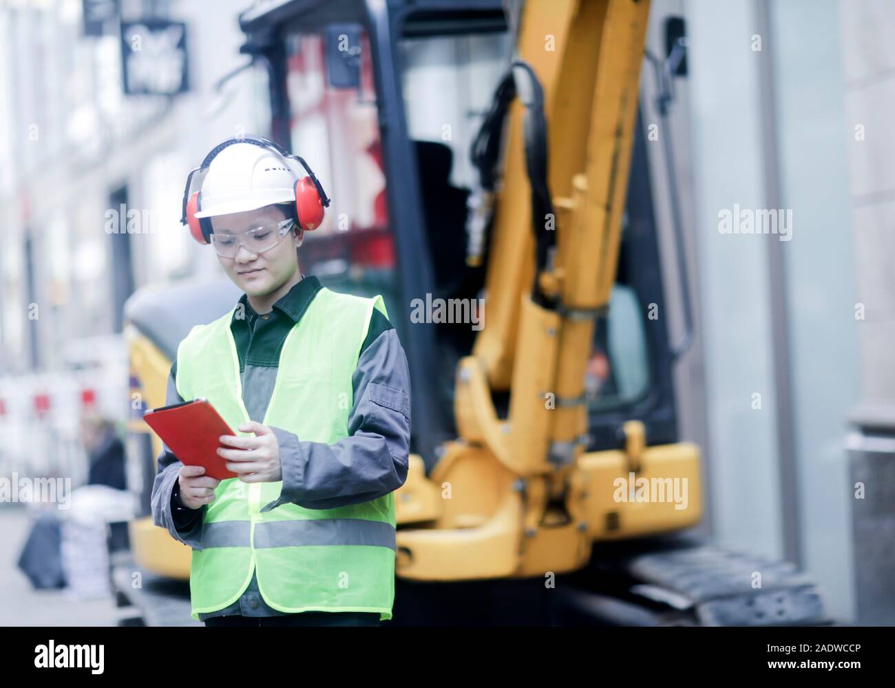 civil engineer standing in front of an excavator Stock Photo - Alamy