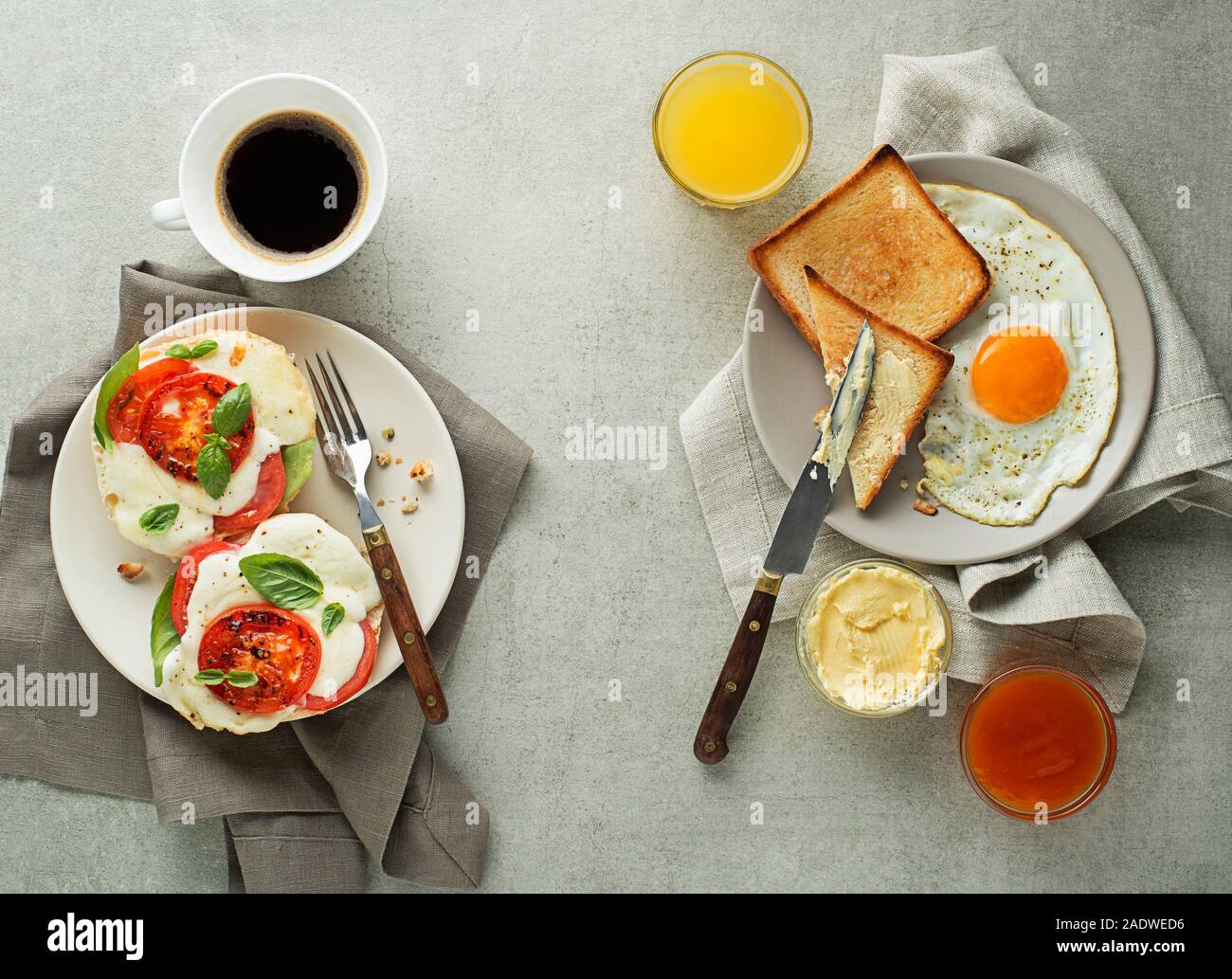 Breakfast buffet served with coffee, juice, jam, butter, fried egg and ...