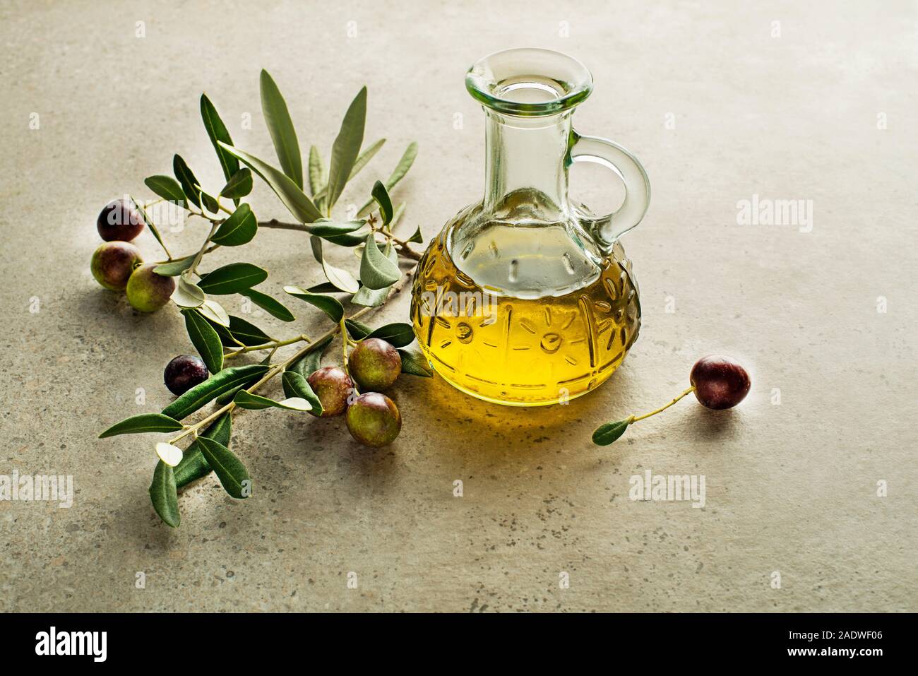 Bottle of Extra virgin healthy Olive oil with fresh olives close up ...