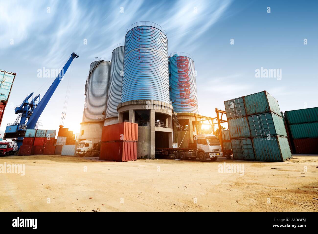 Forklift truck lifting cargo container in shipping yard or dock yard ...