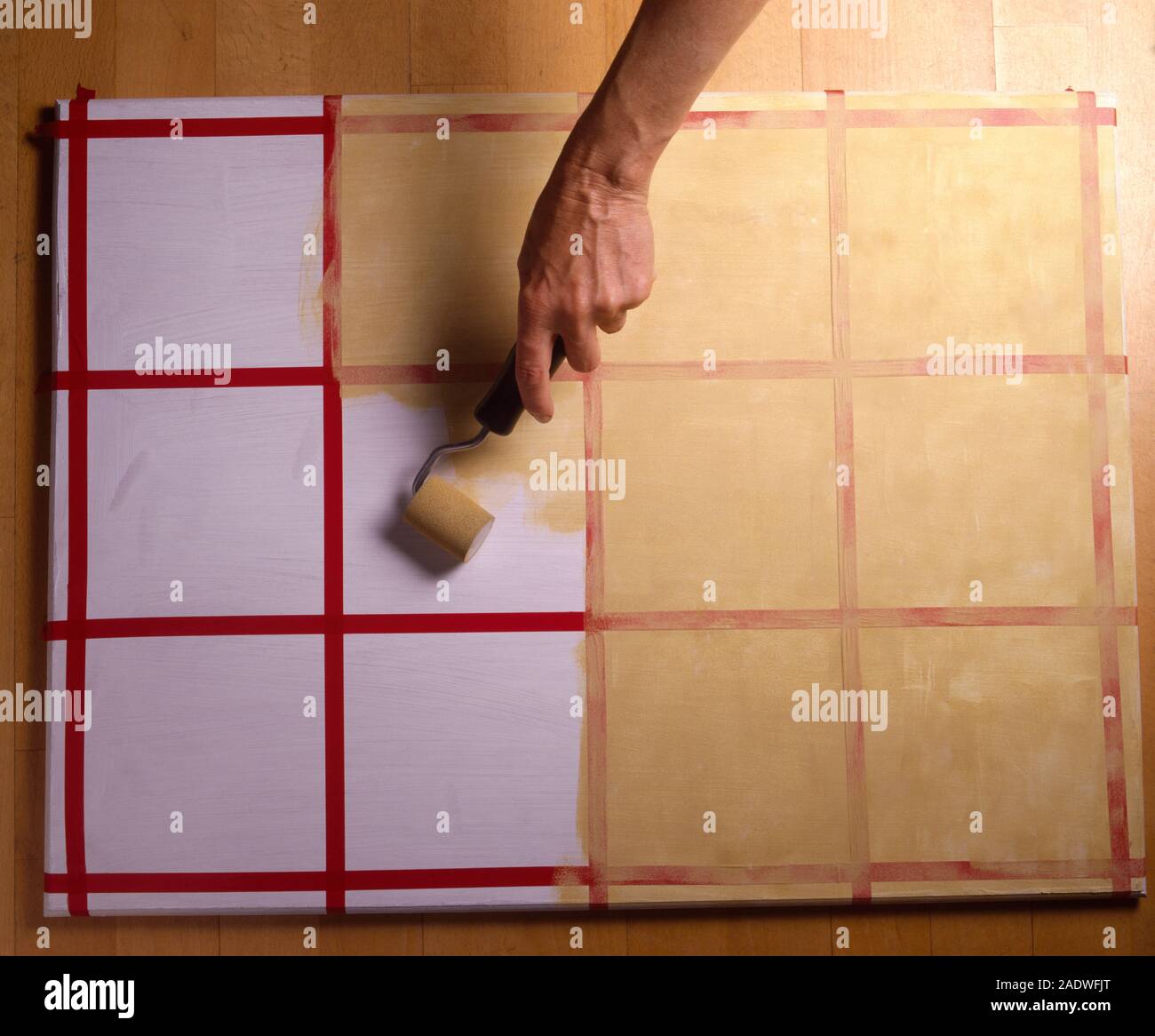 Close-up of a hand filling in squares on a grid with white paint Stock ...