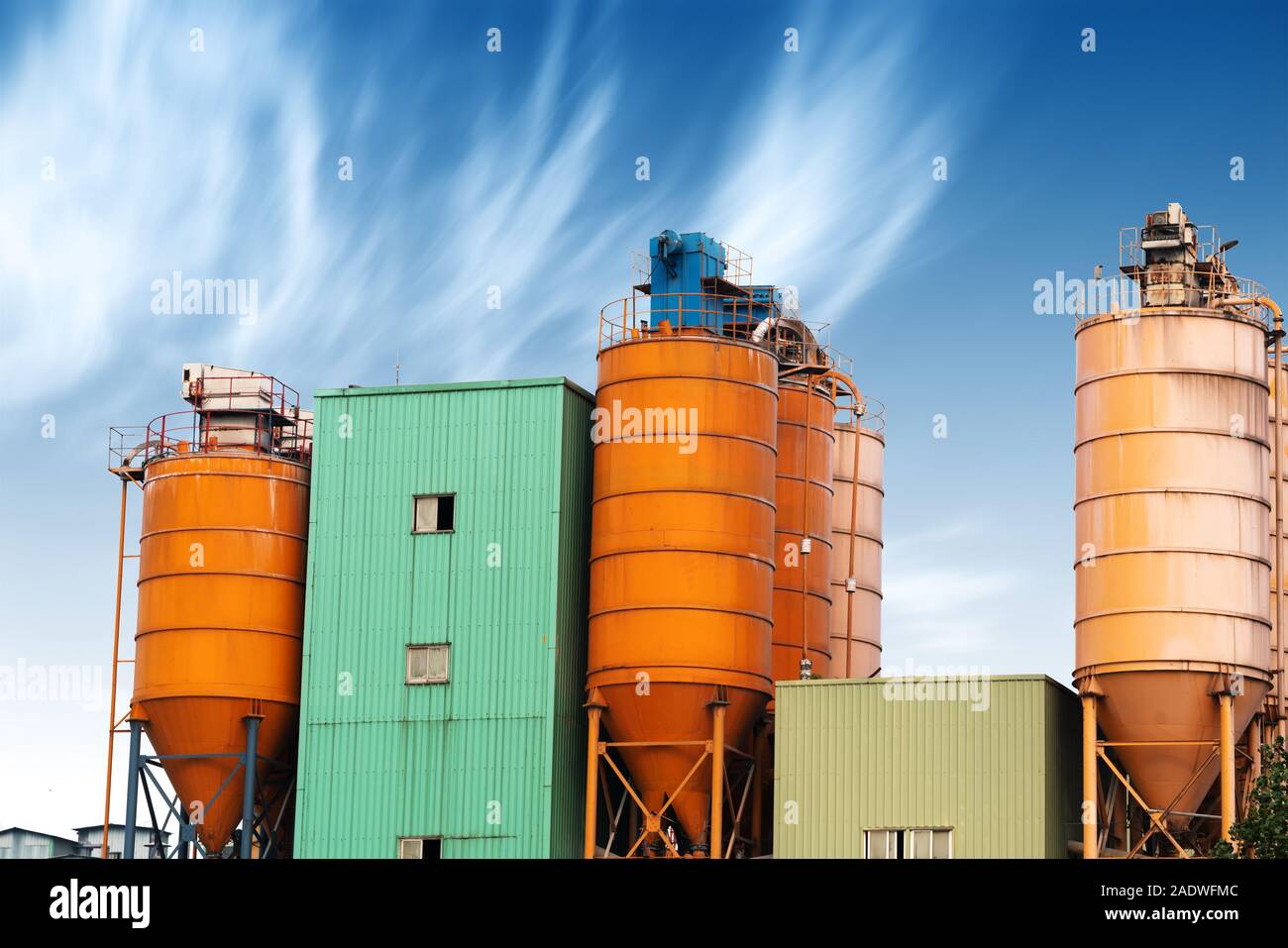 Cement factory machinery on a clear blue day Stock Photo - Alamy