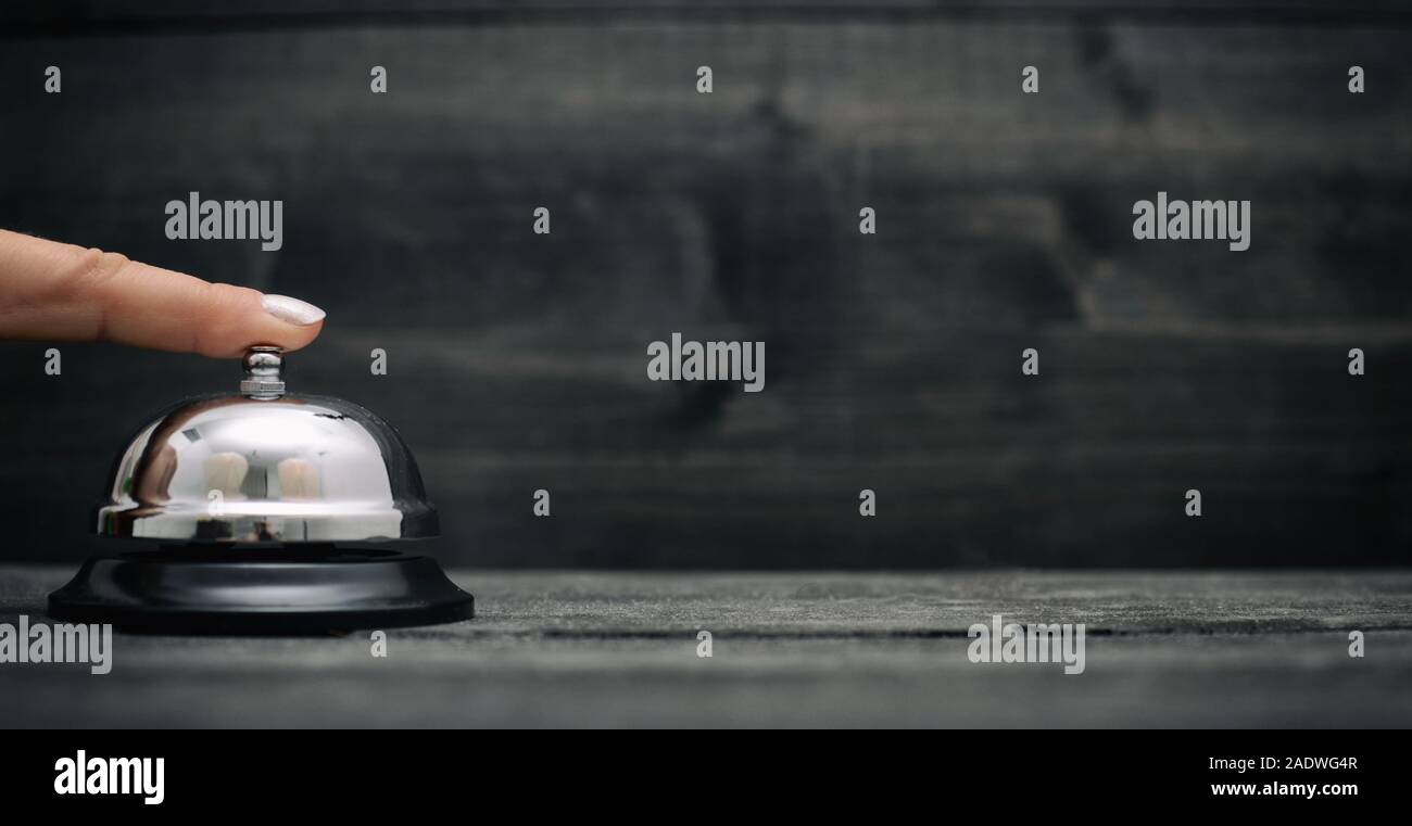 Hotel ring on black wooden background, hotel reception service desk ...