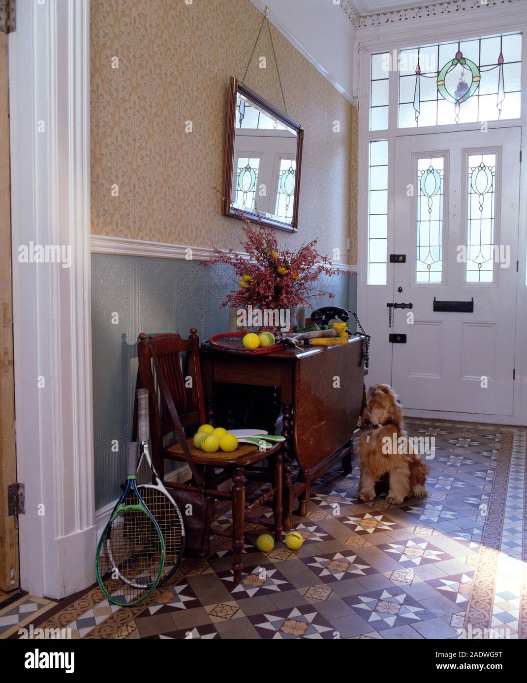 Tennis rackets and an antique gate leg table in an Edwardian style hall ...