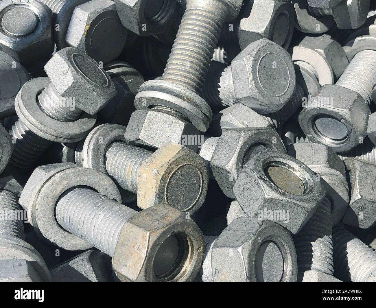 Steel nuts and screws piled in the box. Fastening construction ...