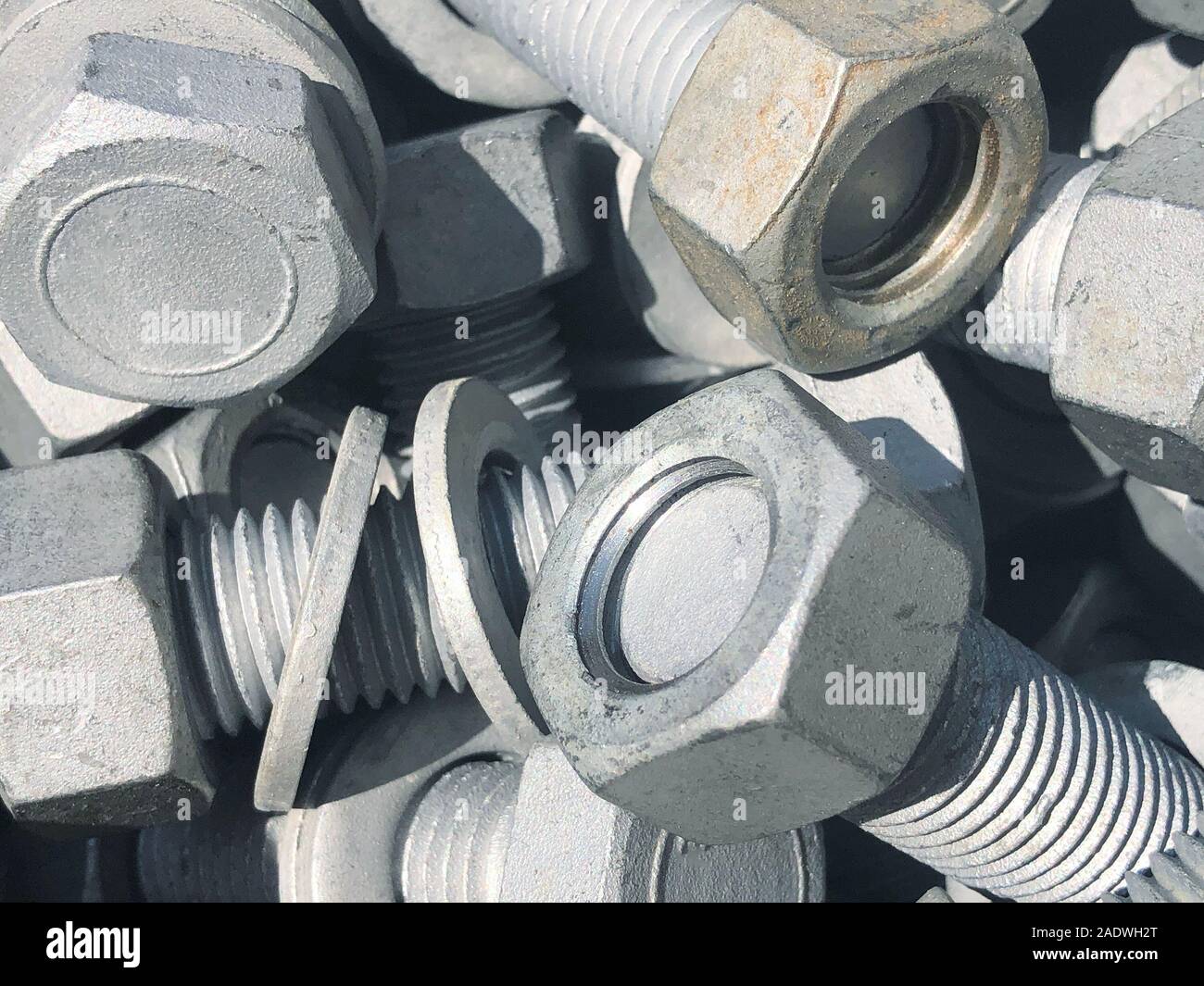 Steel nuts and screws piled in the box. Fastening construction ...
