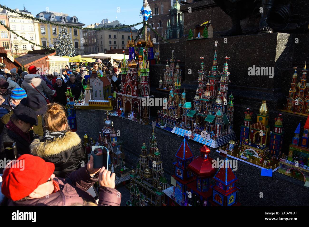 A woman takes a photo of the nativity scene during the 77th edition of ...