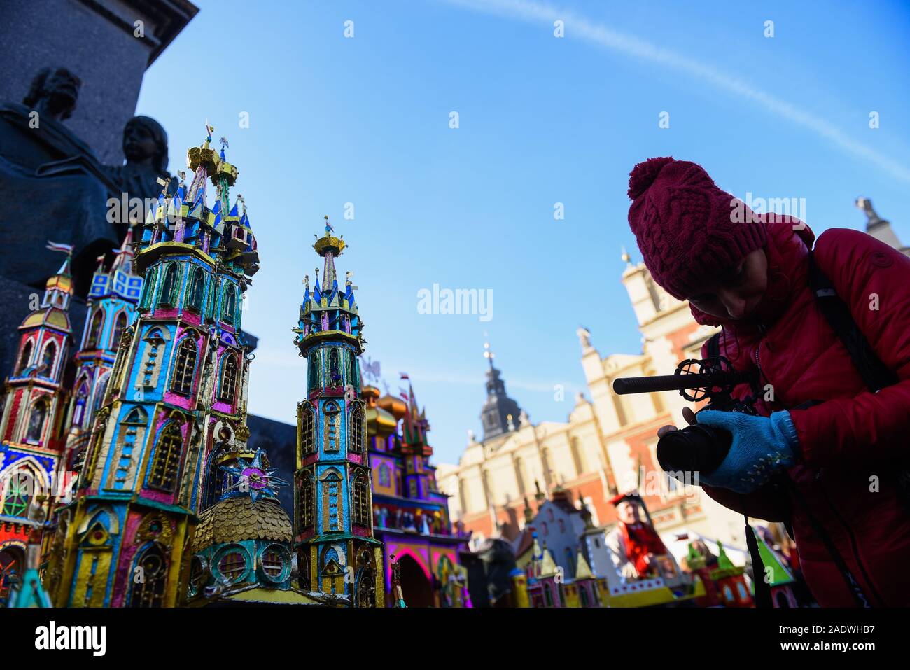 A woman films a nativity scene during the 77th edition of Christmas ...