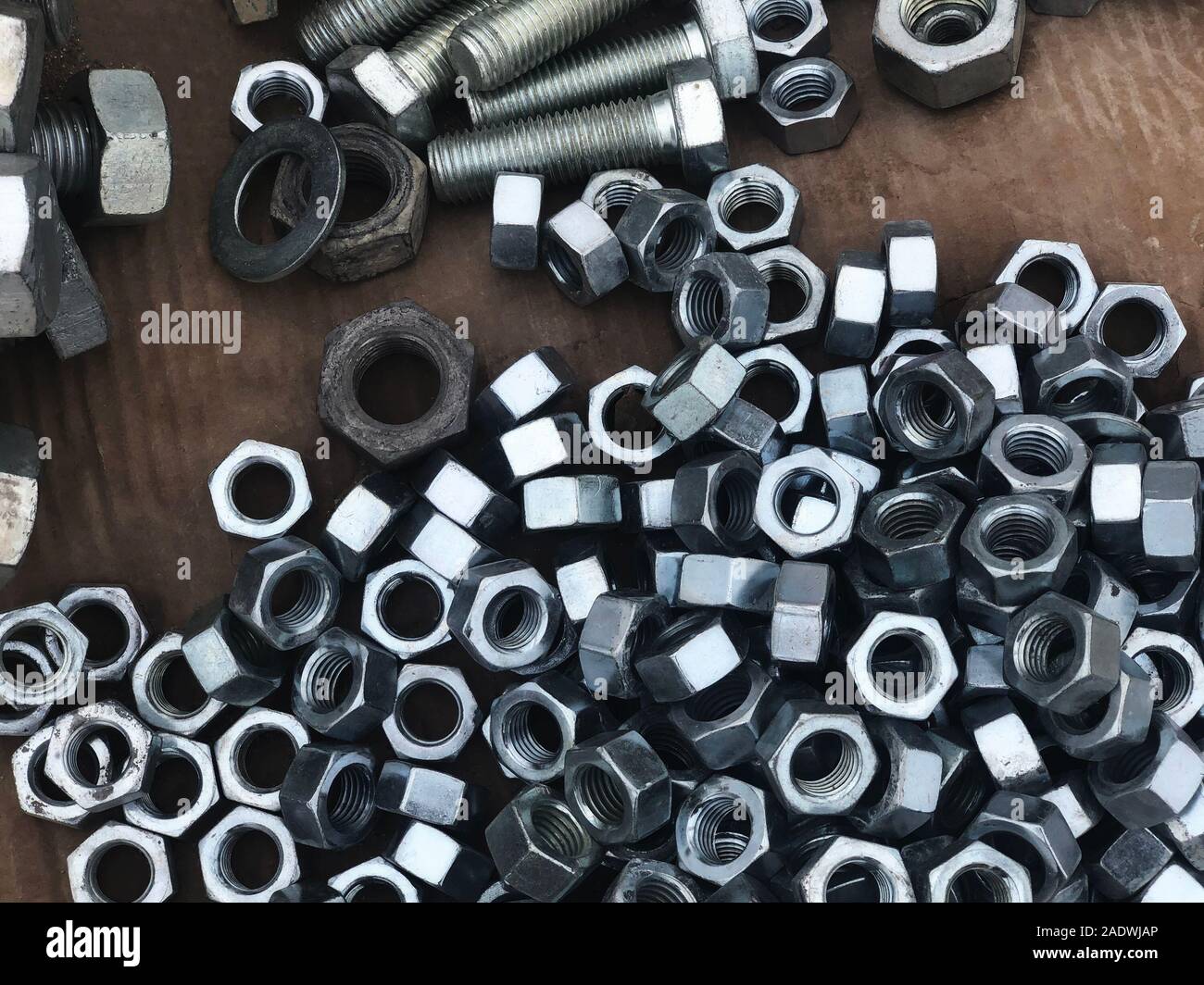 Steel nuts, bolts and washers piled in the box. Fastening construction ...