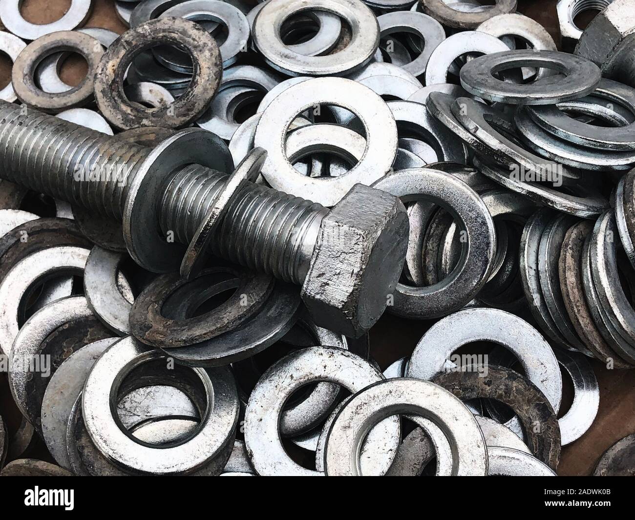 Steel nuts, bolts and washers piled in the box. Fastening construction ...
