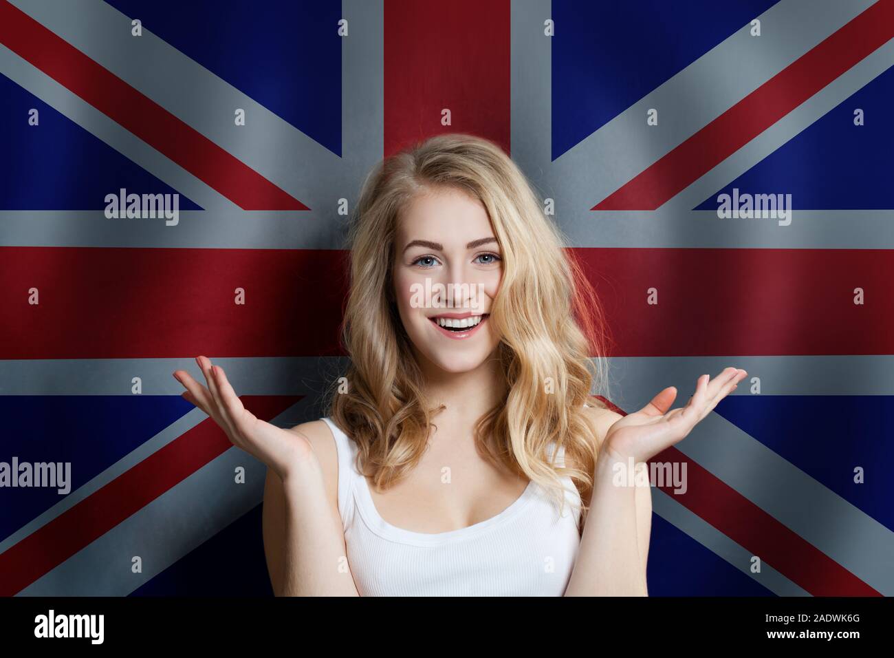 Beautiful happy young woman against the UK flag background. Live ...