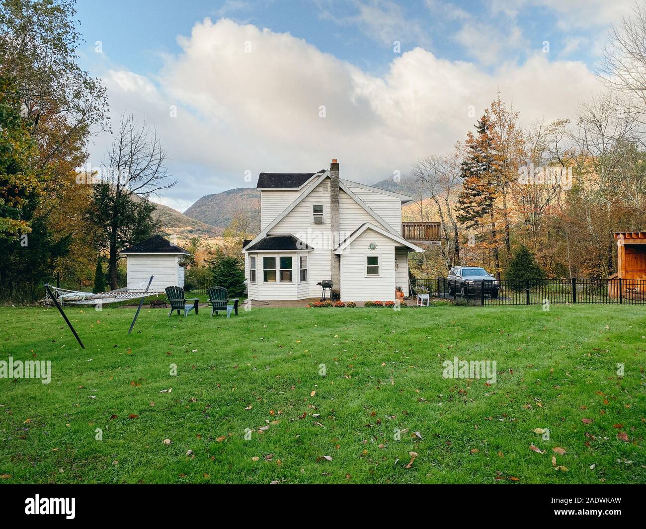 Back Yard view of green lawn and home with mountain views in Autumn ...
