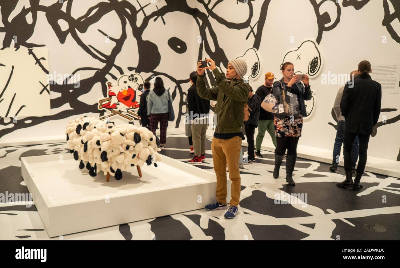 People standing by art by Brian Donnelly aka KAWS sculptor and graffiti ...