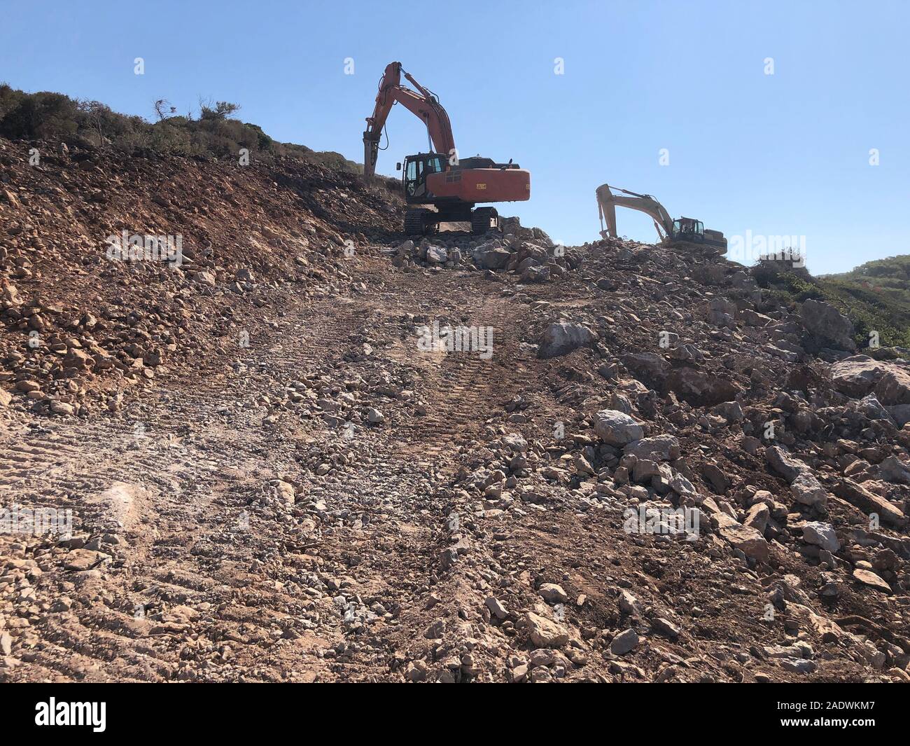 Hydrohammer is crushing rocks during road construction works on the ...