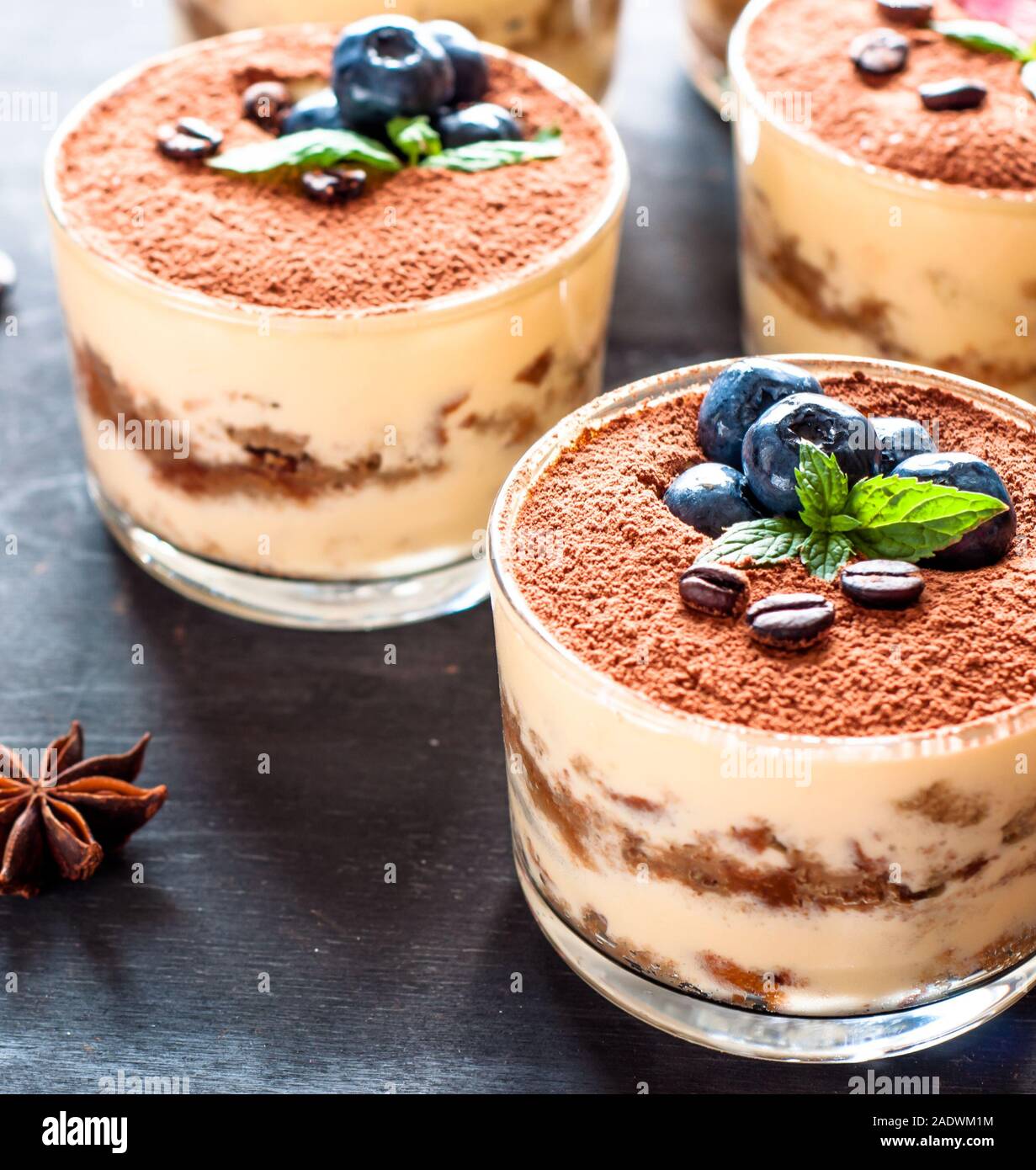 gourmet tiramisu dessert in a glass sprinkled with cocoa and decorated ...