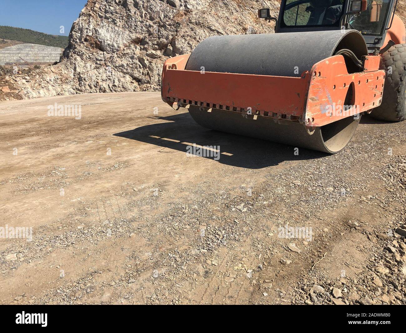 Vibrating roller compresses the soil of a road surface during road ...