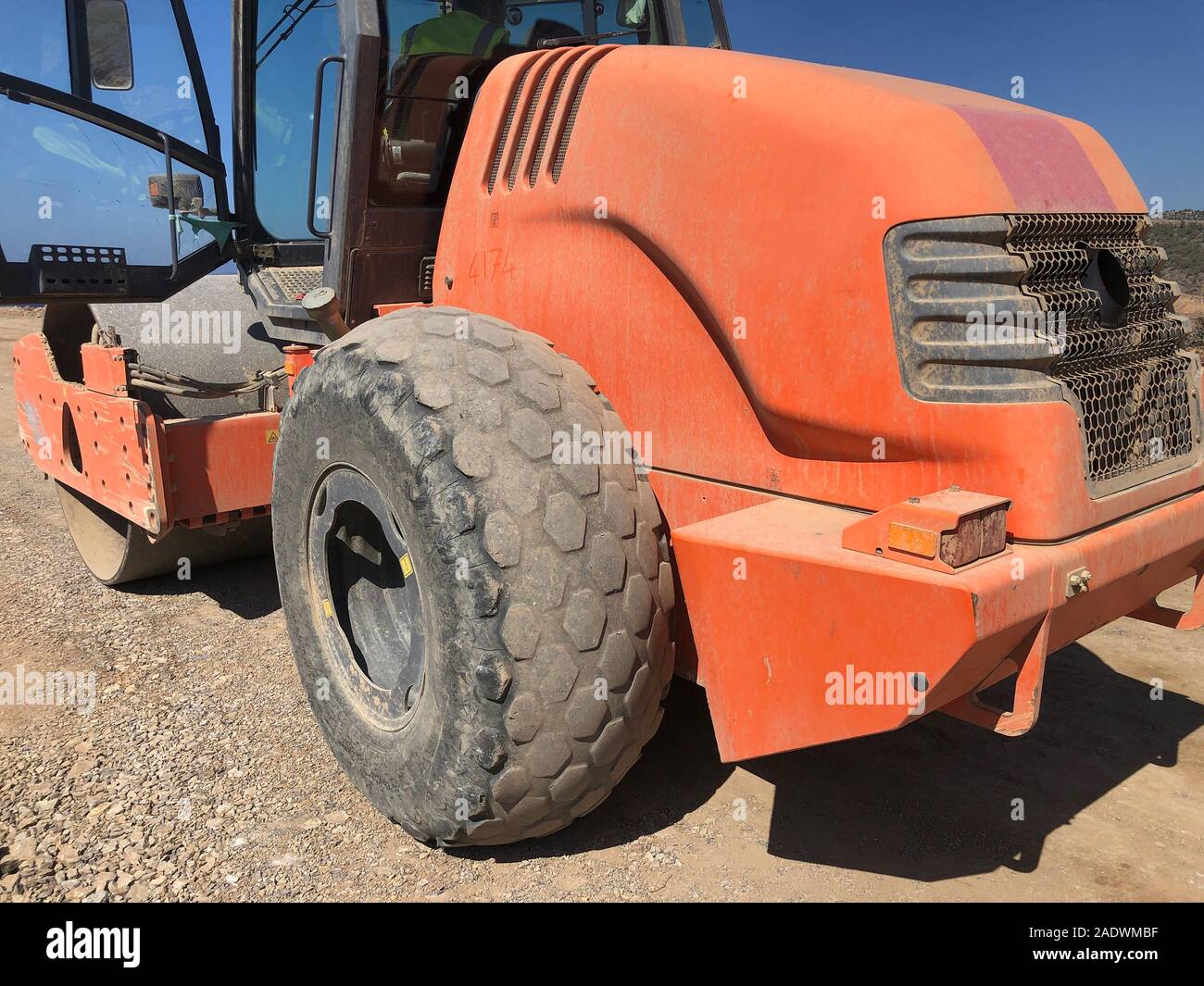 Vibrating roller compresses the soil of a road surface during road ...