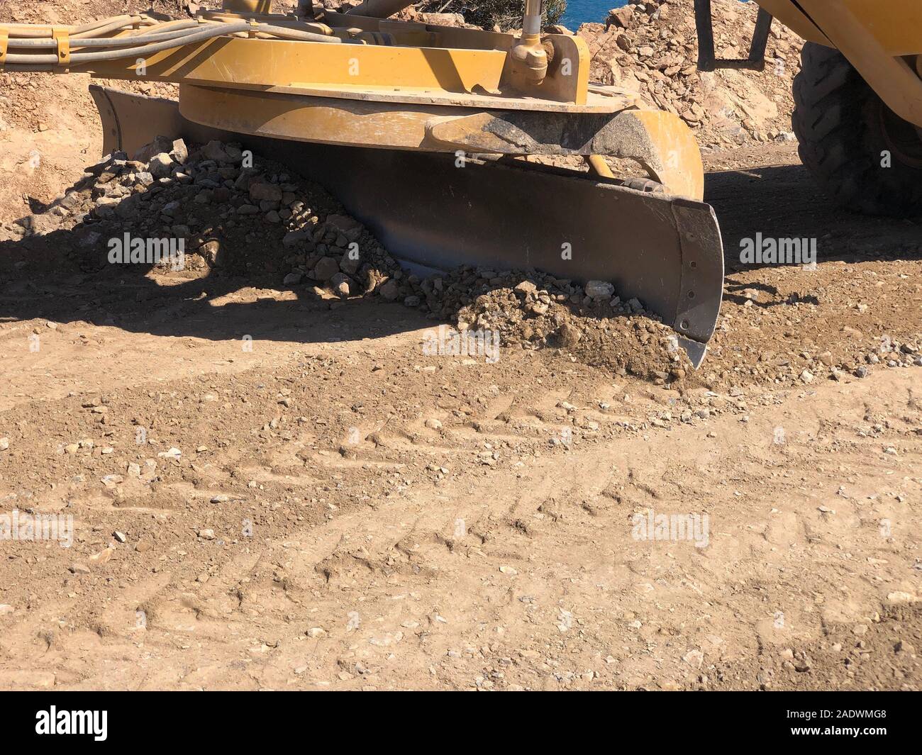 Close-up of moldboard planning road surface. Blade of motor grader ...