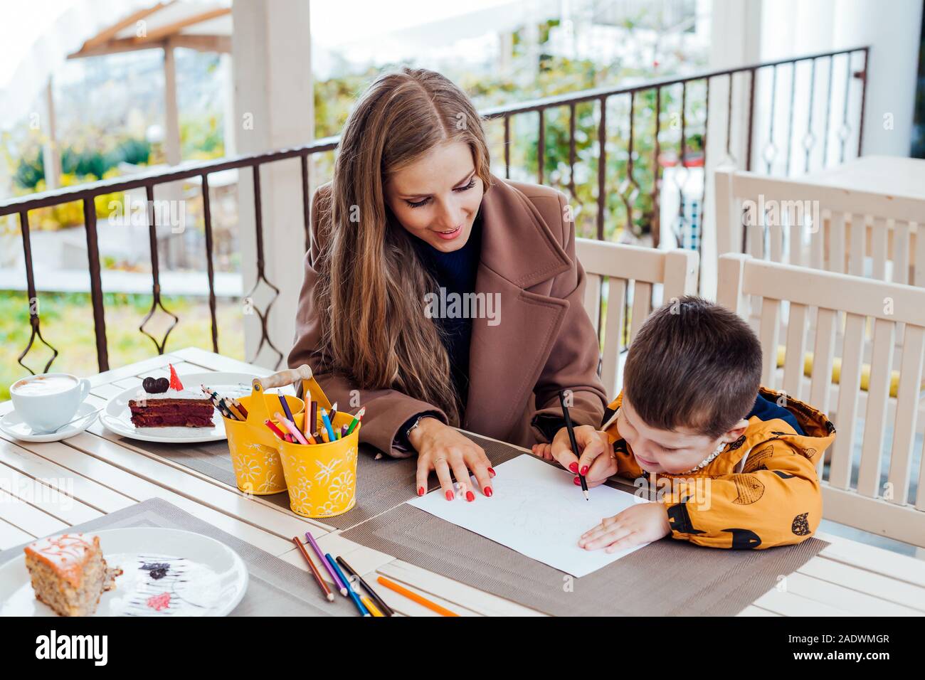 mom helps son to draw drawing colored pencils Stock Photo - Alamy